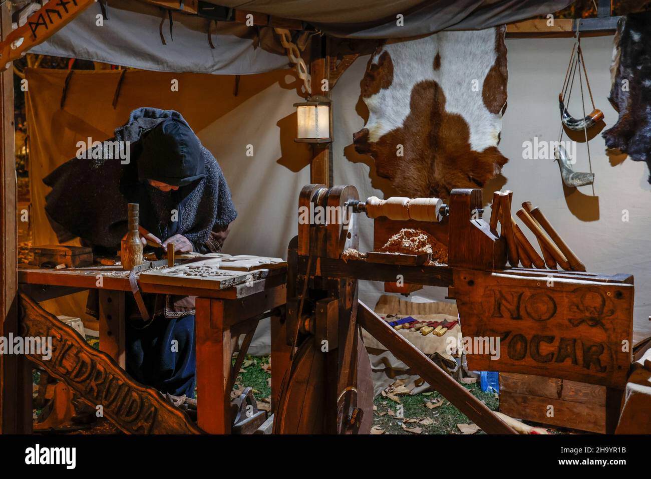 Carpenter working with wood in the Medieval Christmas market in the ...