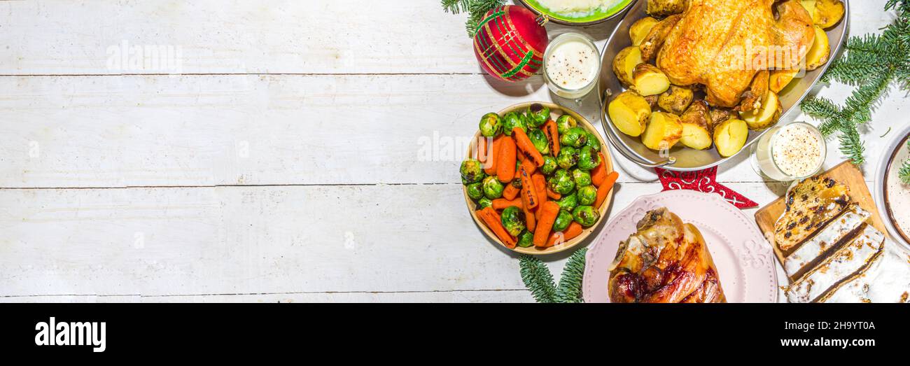 Festive Christmas dinner table with traditional foods and dished ...
