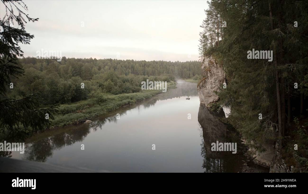 Landscape with river flowing in forest area in cloudy weather. Stock ...