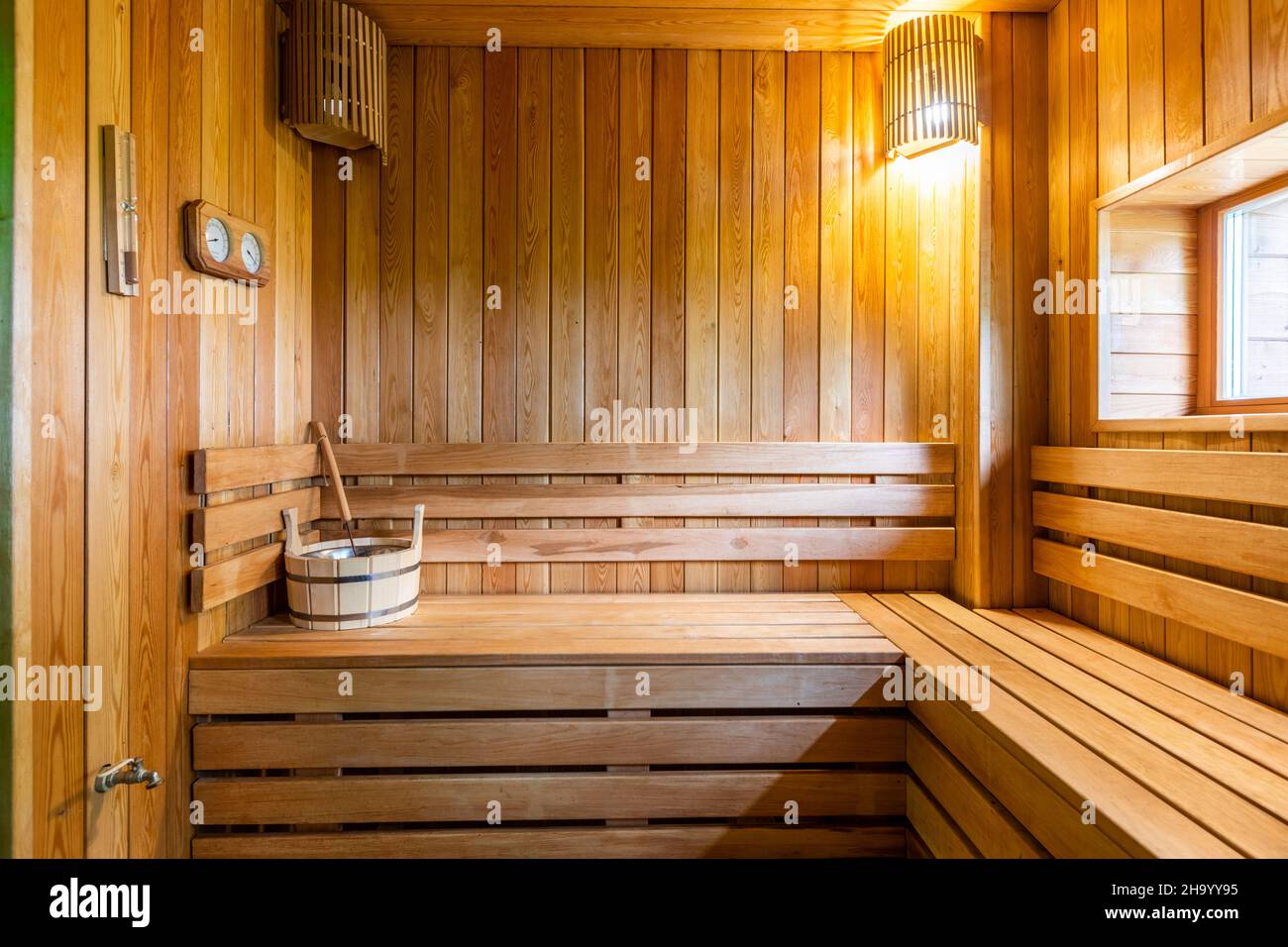 interior of a classic Finnish sauna with a window and shelves made of ...