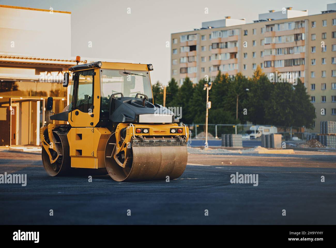 Road reconstruction. Heavy vibration road roller stacking hot asphalt ...