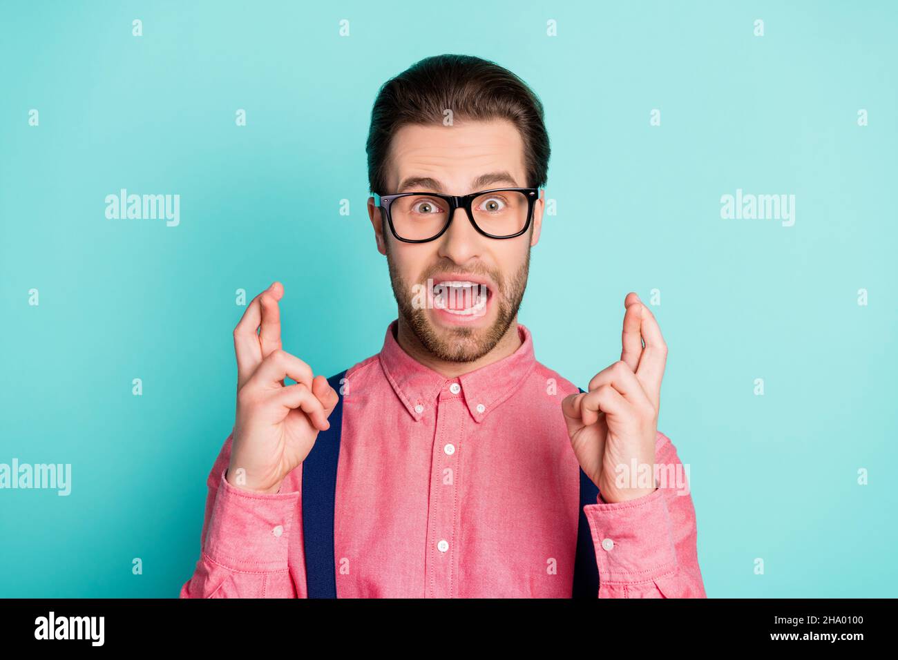 Photo of young man nervous worried crossed fingers hope wish luck ...