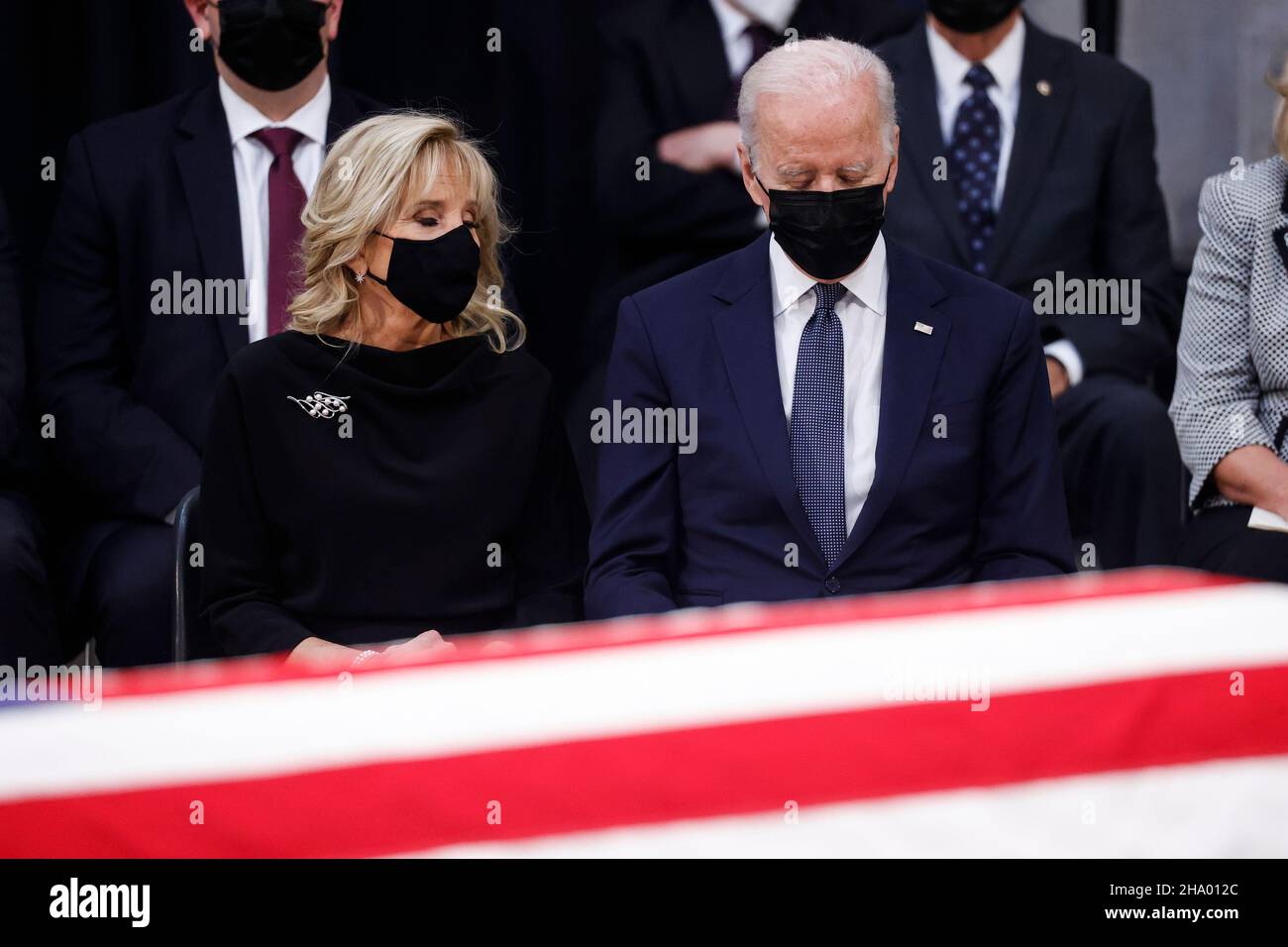 U.S. President Joe Biden and first lady Jill Biden sit near the casket ...