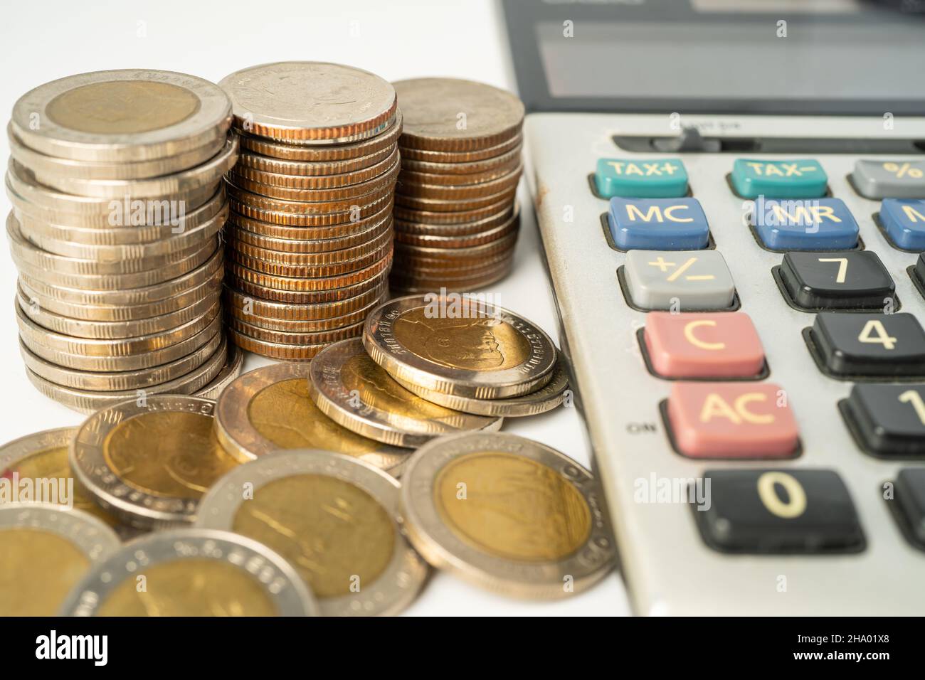 Coins on calculator and graph paper. Finance development, Banking ...