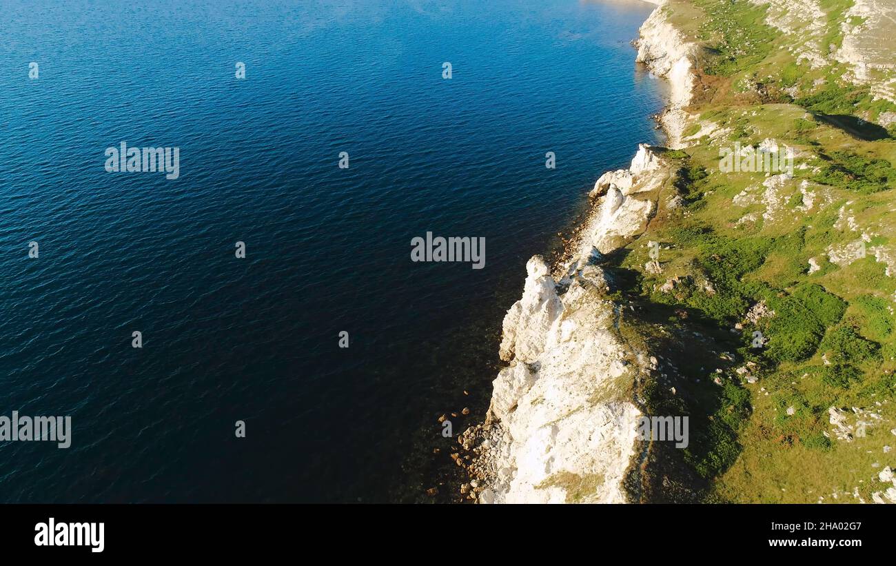 Aerial view of sea waves and fantastic Rocky coast. Shot. Top view of ...
