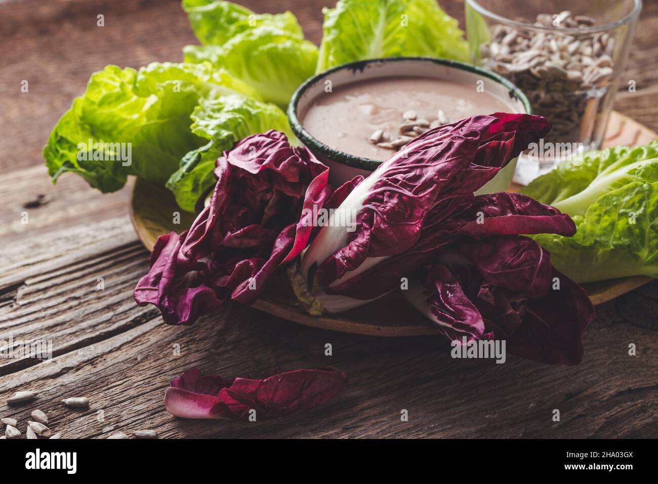 Raw organic purple radicchio and lettuce with salad dressing and ...