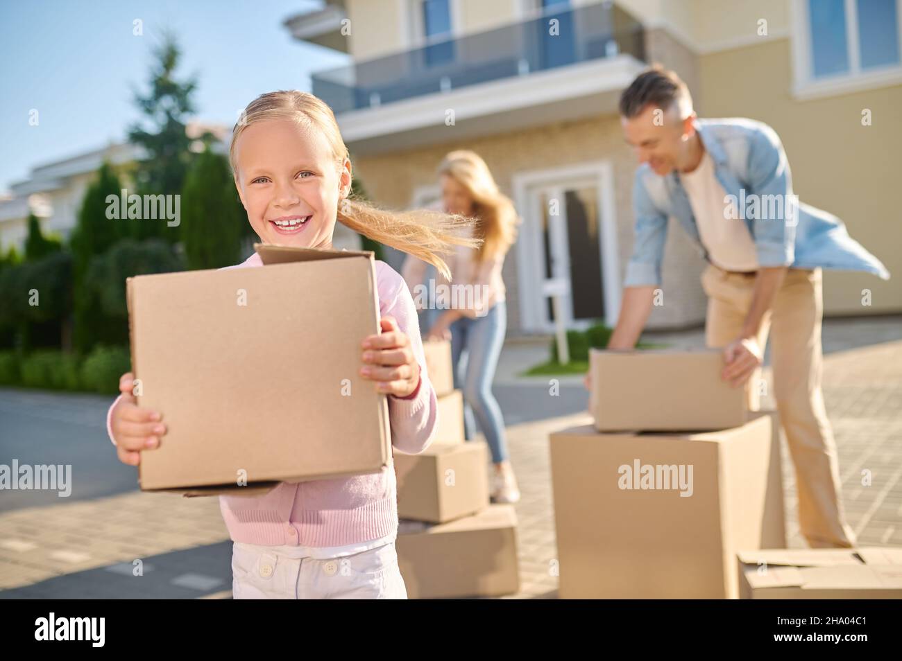 Cute family unpacking cardboard boxes while moving to a new house Stock ...