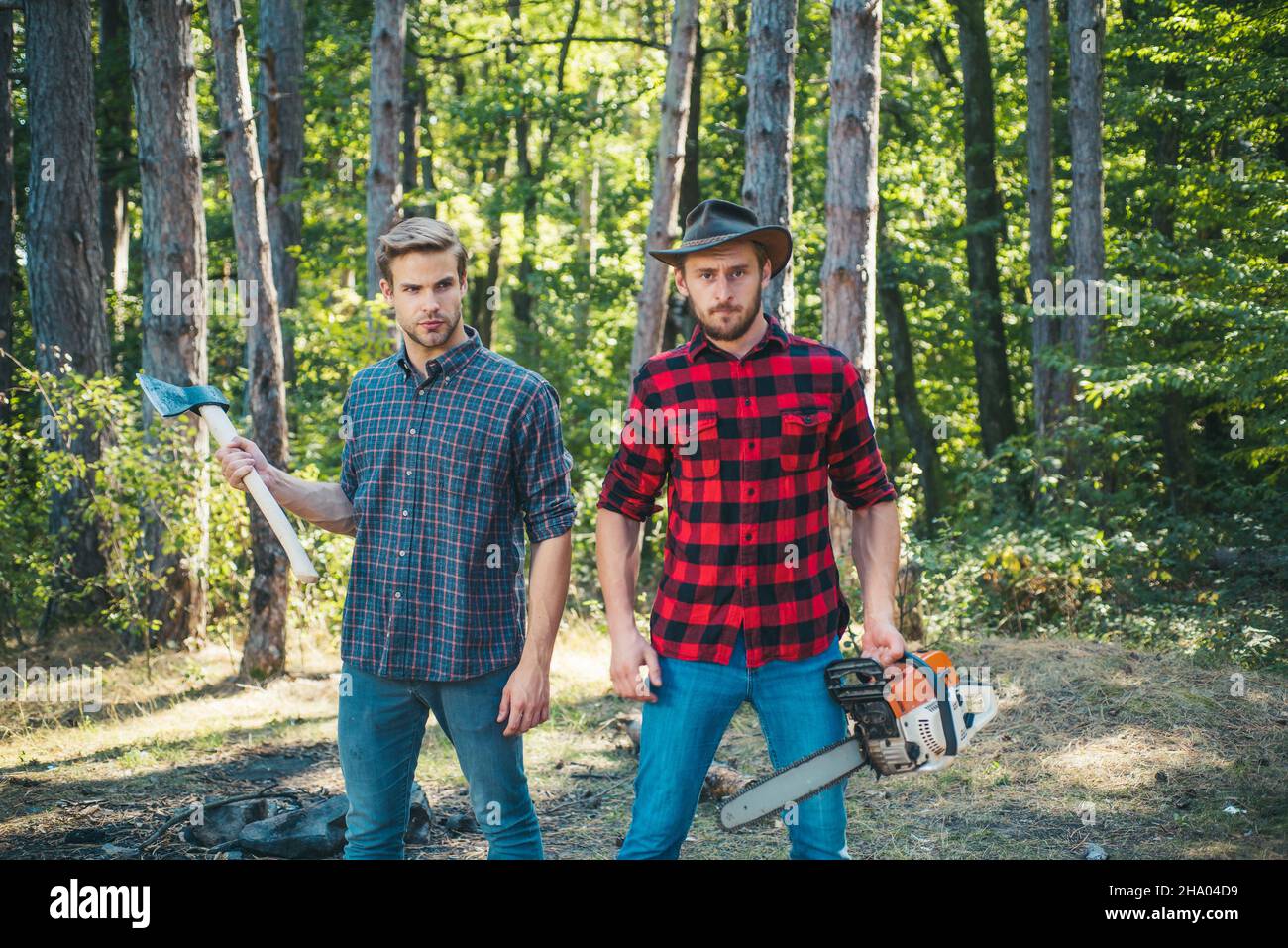 Man woodcutter holding ax. Axe in lumberjack hands cutting wood ...