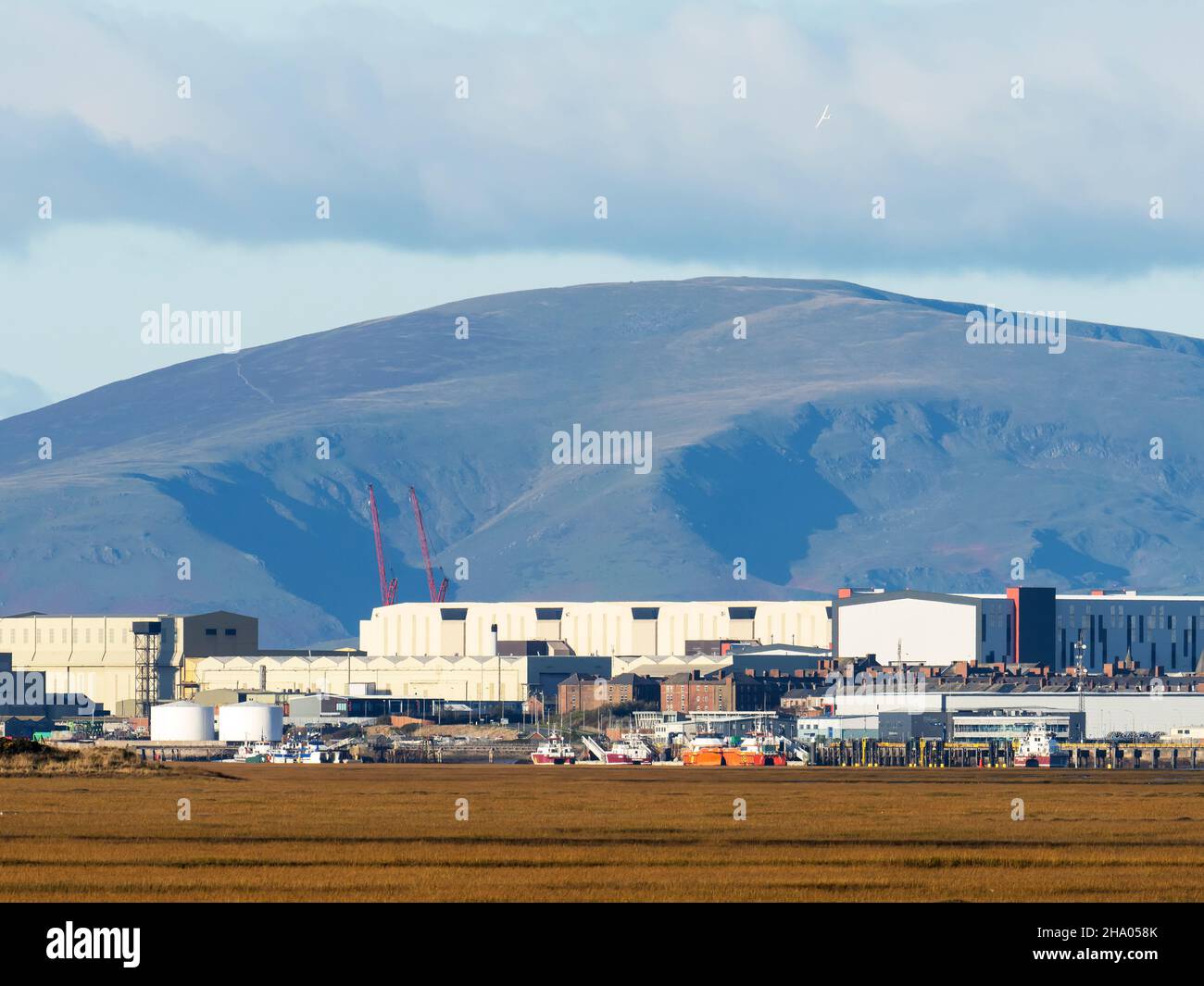 The shipyard in Barrow in Furness, Cumbria, UK, with a glider flying ...