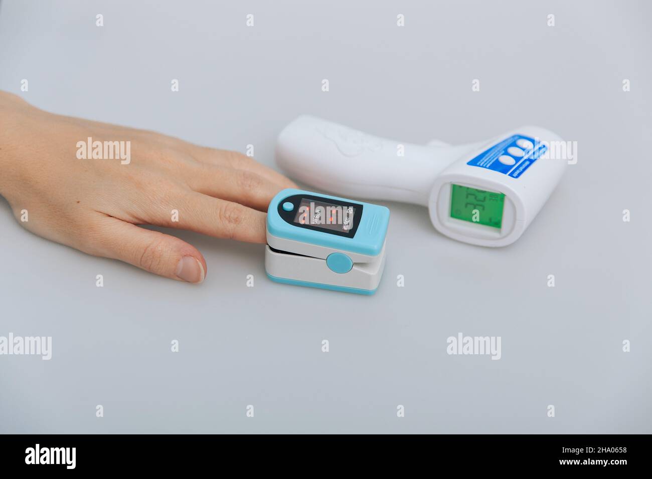 Pulse oximeter and thermometer gun on white background. Infrared ...