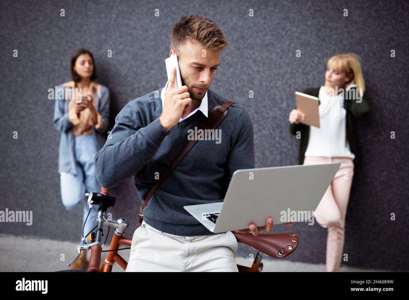 Group of business people using electronic devices outdoor Stock Photo ...