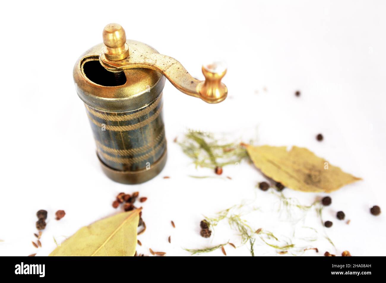 vintage brass mill or grinder and some spices Stock Photo - Alamy