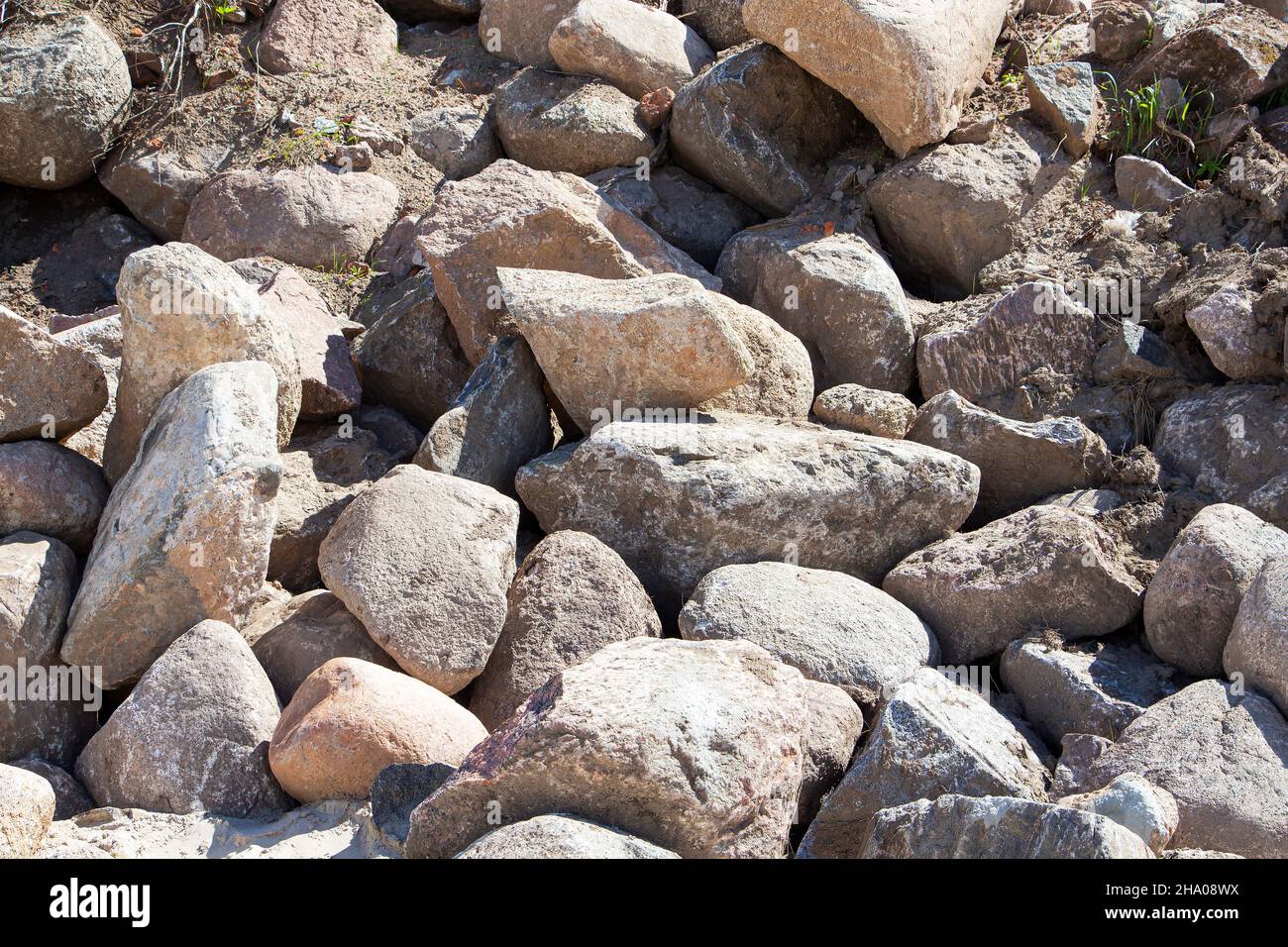 Rockfall on the road in the mountains. Stones of different sizes ...