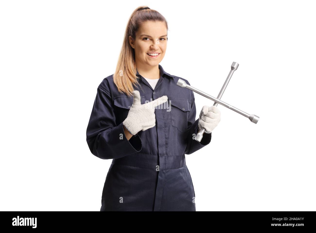 Female car mechanic holding a lug wrench and pointing isolated on white ...
