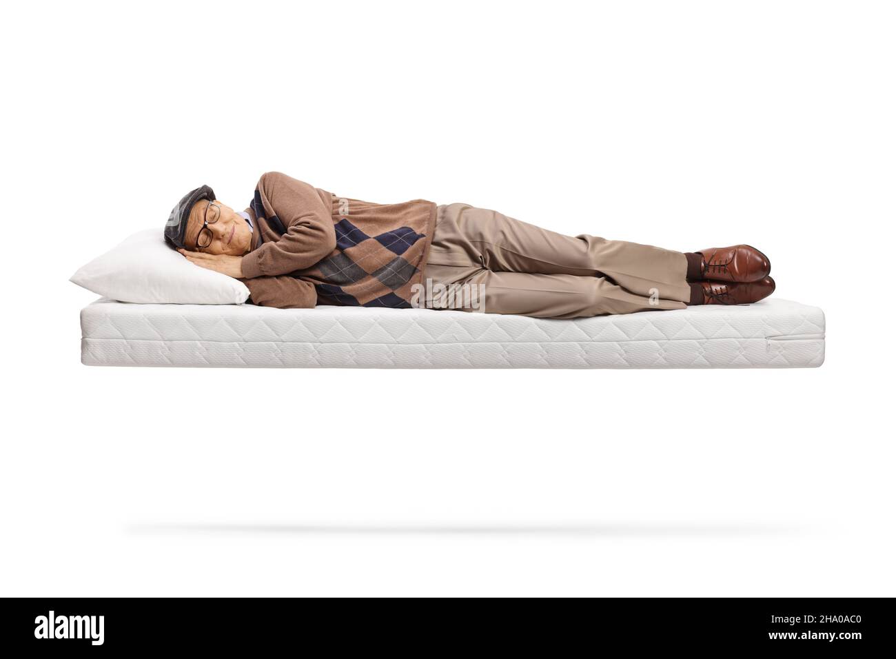 Senior man sleeping on a floating matress isolated on white background ...
