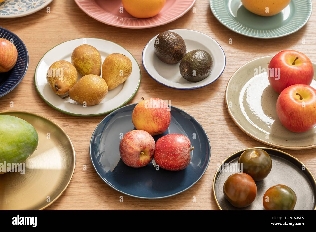 set of plates full of different fruits and vegetables on oak table ...