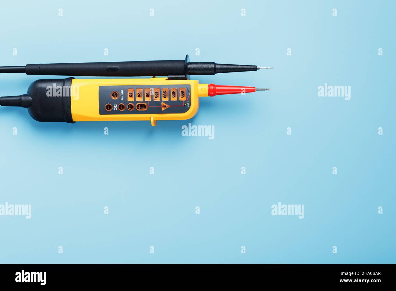 Two-pole voltage indicator close-up on a blue background. Testing and ...