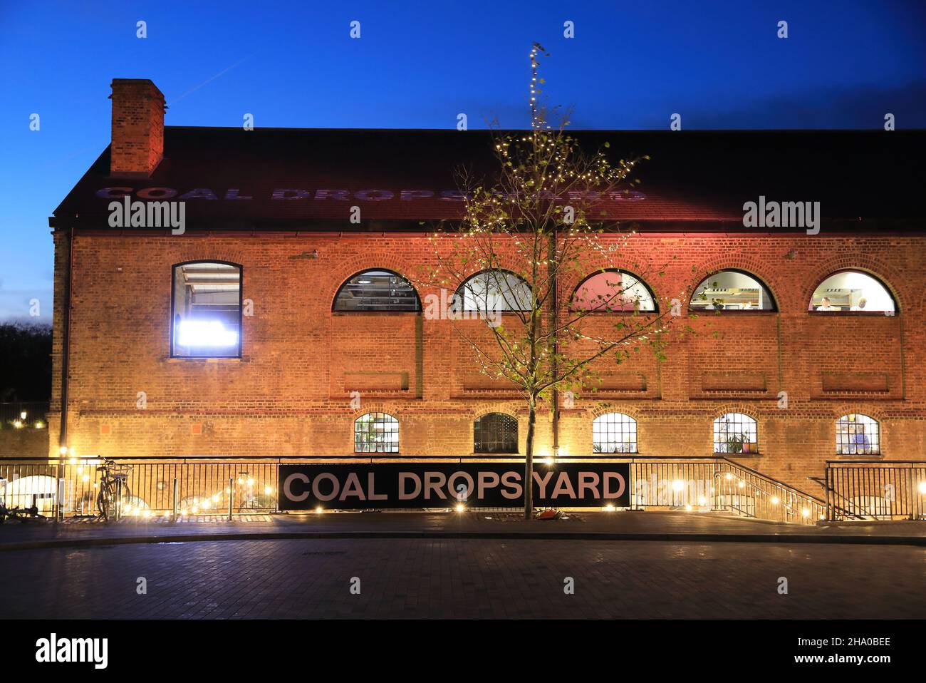 Coal Drops Yard historic building, at dusk in winter, at Kings Cross ...