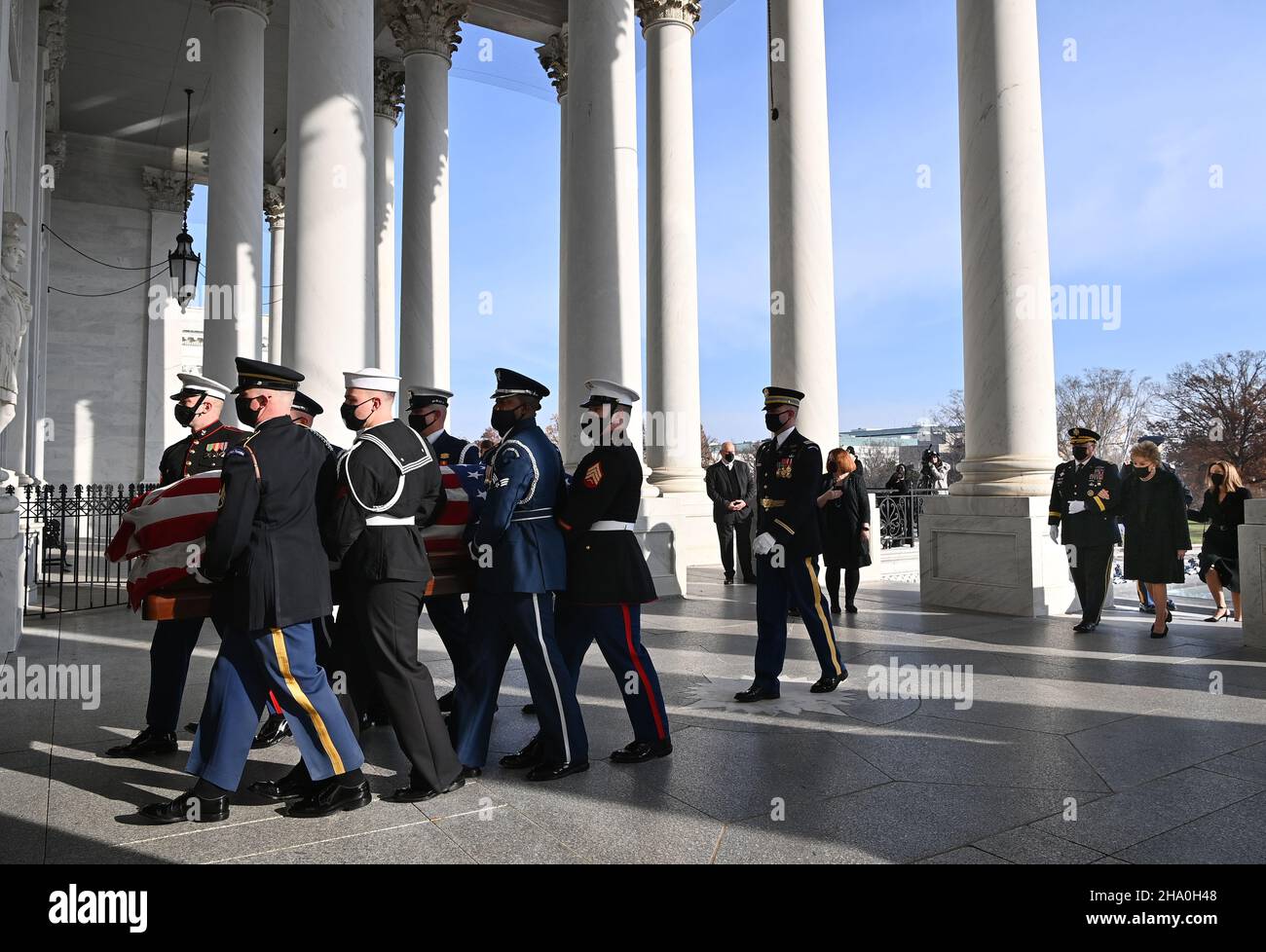 The casket of former US senator Bob Dole followed by his wife Elizabeth ...