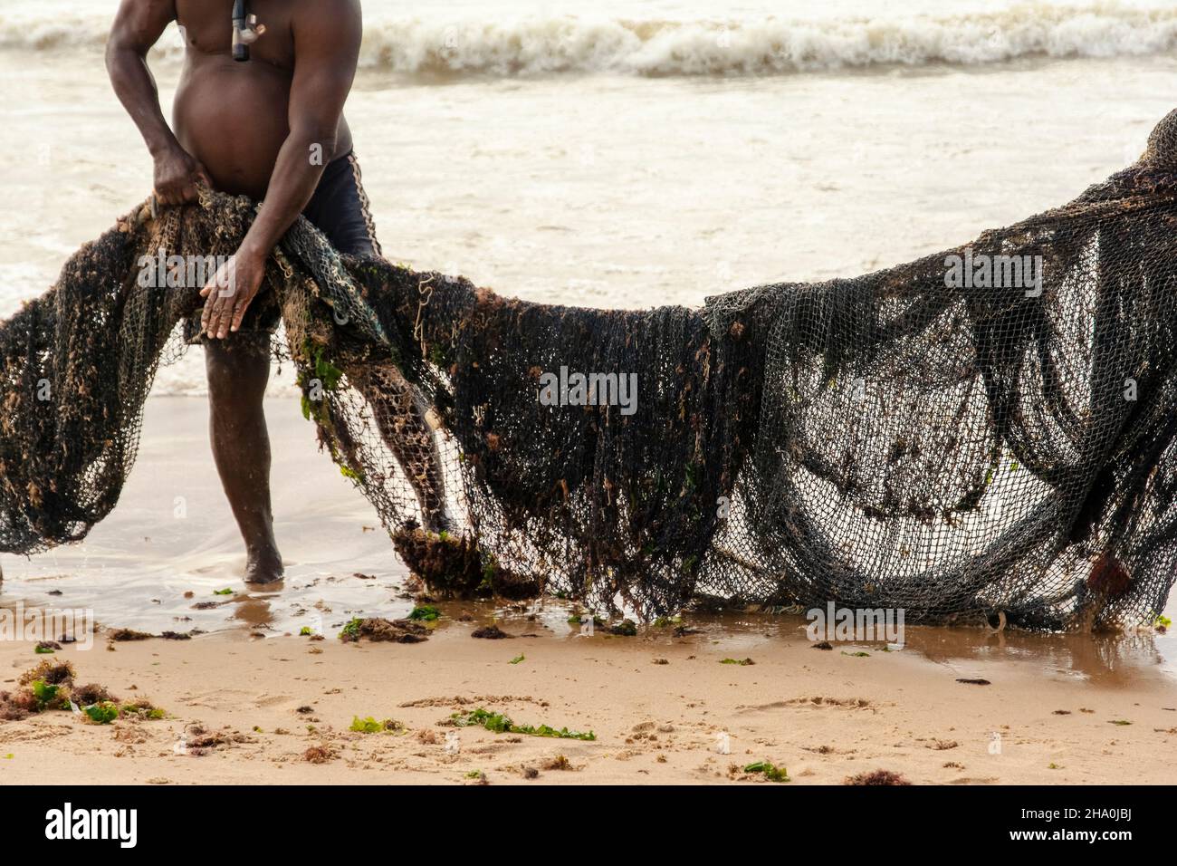 Fishermen pulling their fishing net out of the sea Stock Photo - Alamy