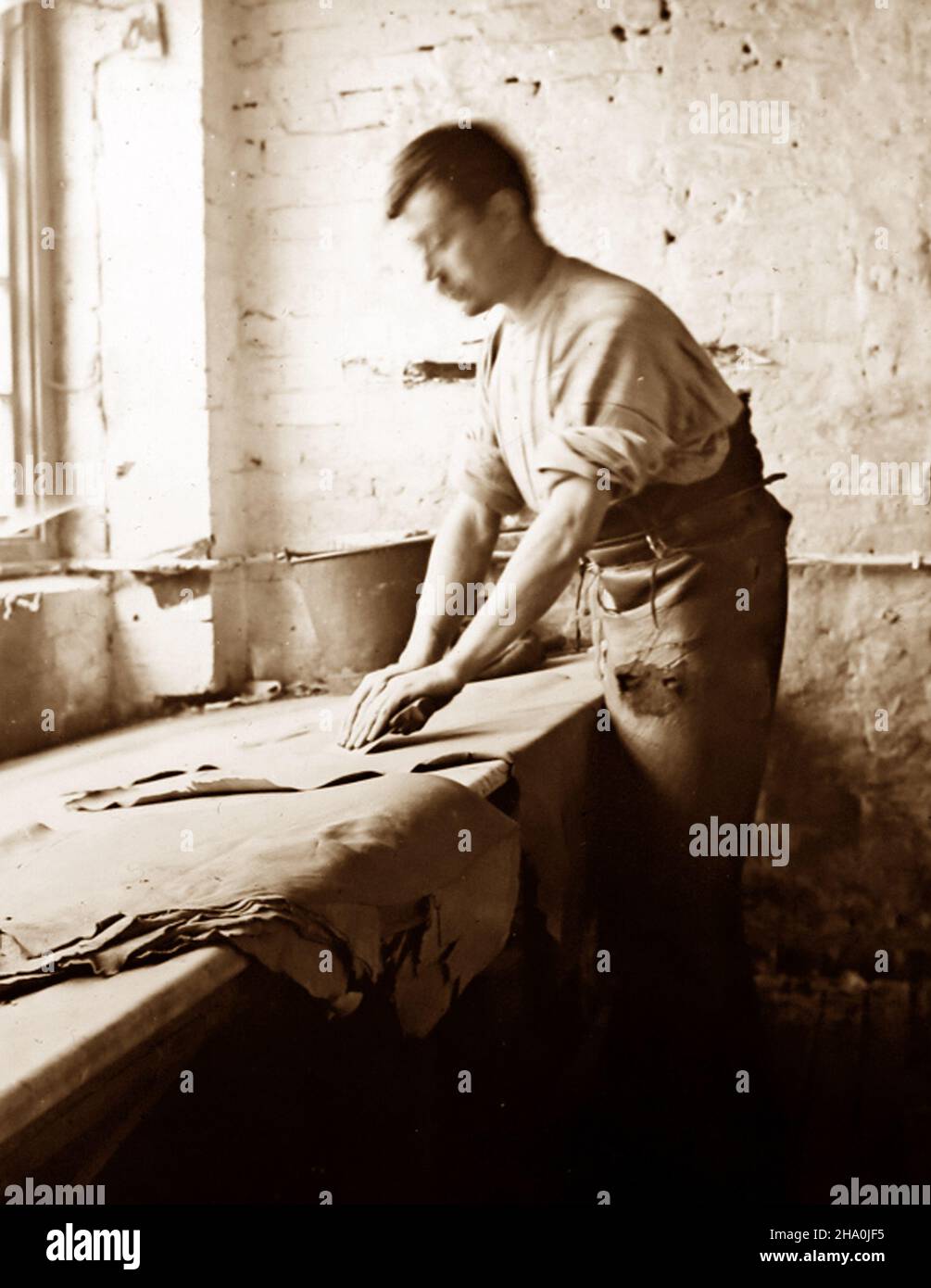 Sewing skins, leather production, Victorian period Stock Photo - Alamy