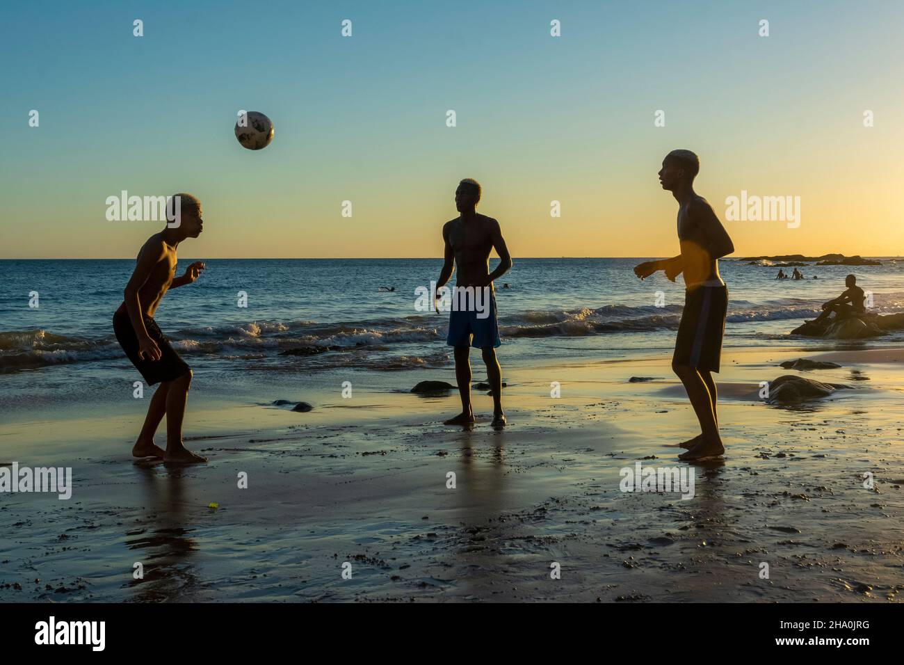 Young people playing sand football at sunset on Ondina beach in ...