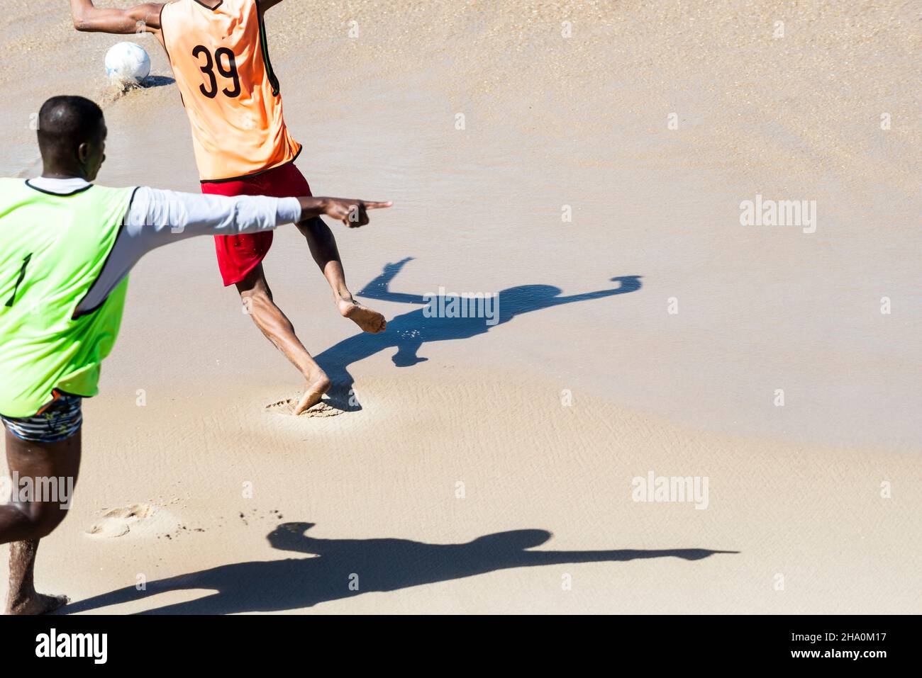 People playing sand football at Farol da Barra beach in Salvador city ...