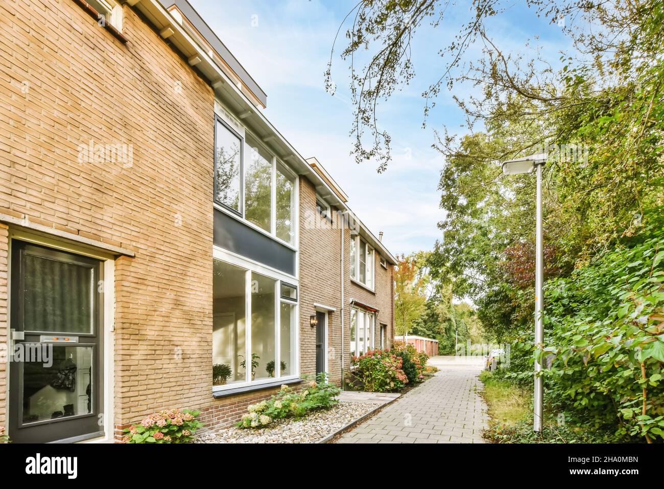 View of a two-storey house with large windows Stock Photo - Alamy