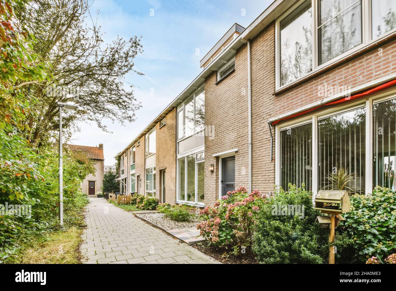 View of a two-storey house with large windows Stock Photo - Alamy