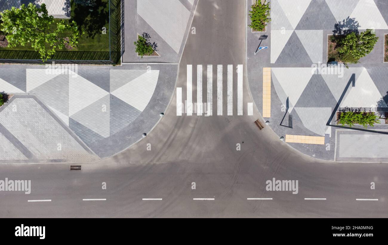 aerial top view of street with parking lot near new residential housing ...