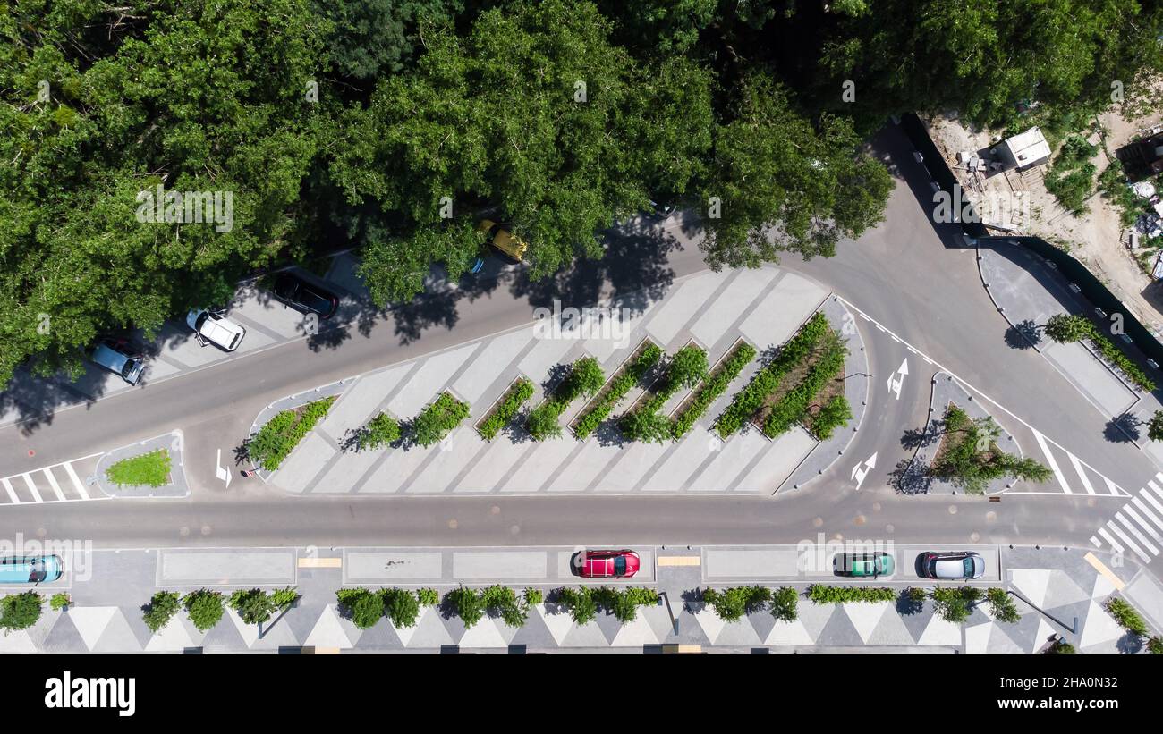 aerial top view of street with parking lot near new residential housing ...
