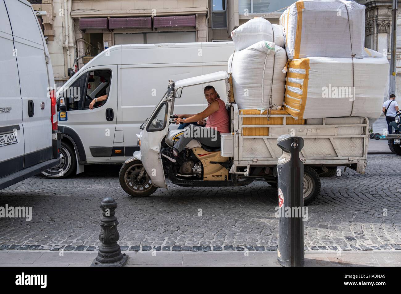 Man carrying huge packets with small motor in Istanbul Stock Photo - Alamy