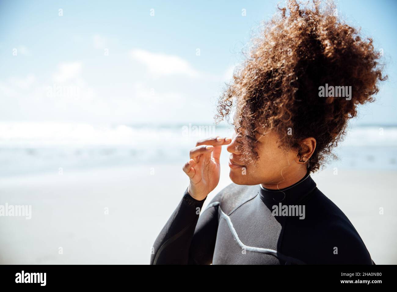 Woman applying sunscreen on the beach Stock Photo - Alamy