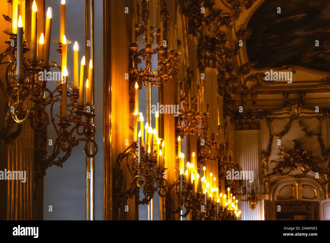 Interior of a luxury building with lit artificial candles and golden ...