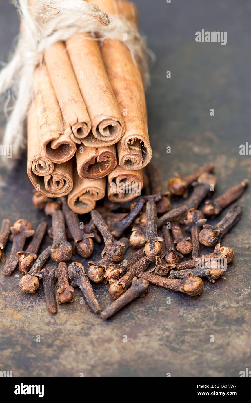 Christmas food spices, cloves and cinnamon sticks in the kitchen ...