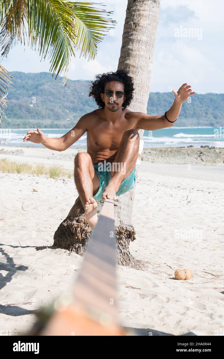 Man doing slackline on the beach Stock Photo - Alamy