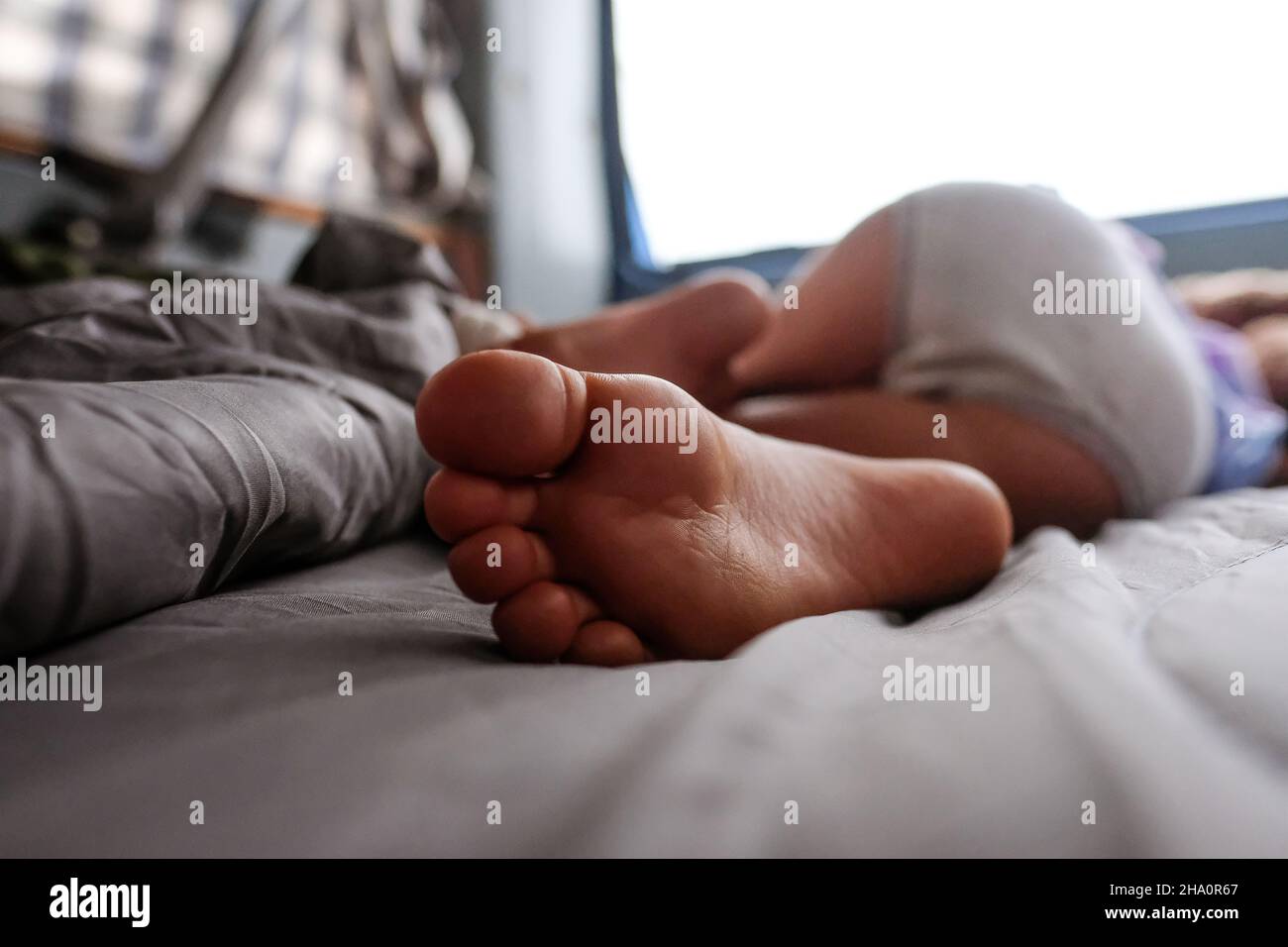 close up of little girl foot while sleeping Stock Photo - Alamy