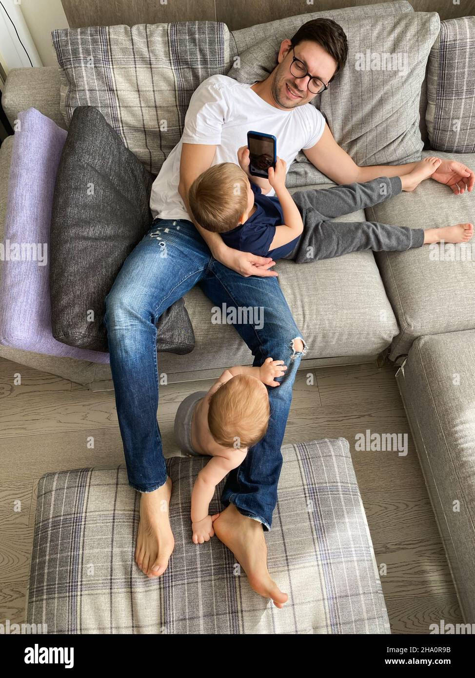 Son making photo of father during self isolation Stock Photo - Alamy