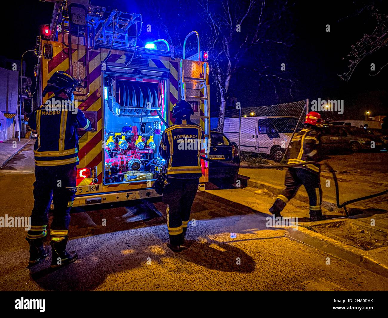 firefighters and fire truck working on a fire Stock Photo - Alamy