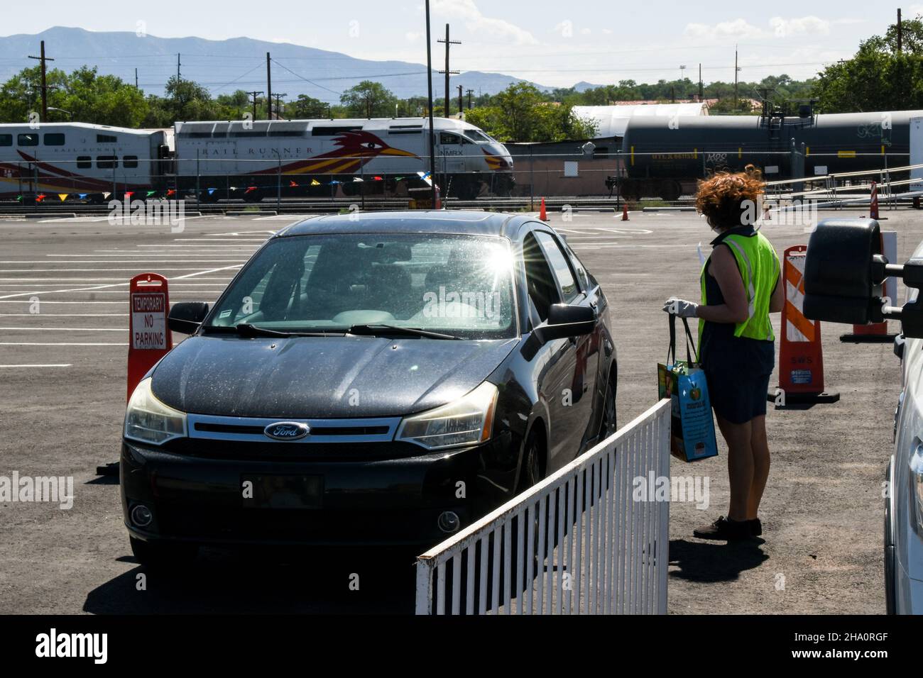 Food handouts at drive up food bank at the Railyard in June 2020 ...