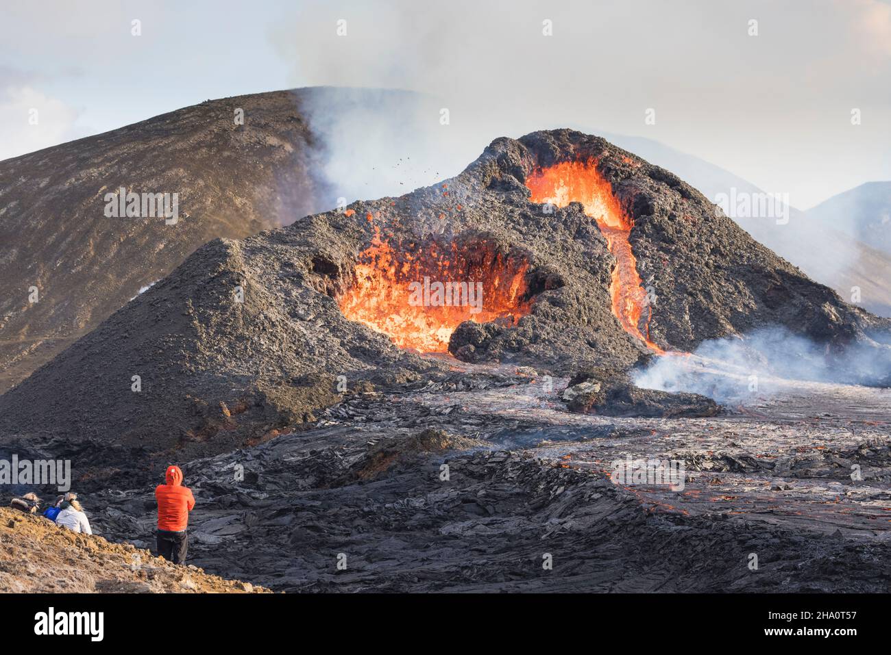 security man observe incandescent flowing volcanic lava in volcano ...