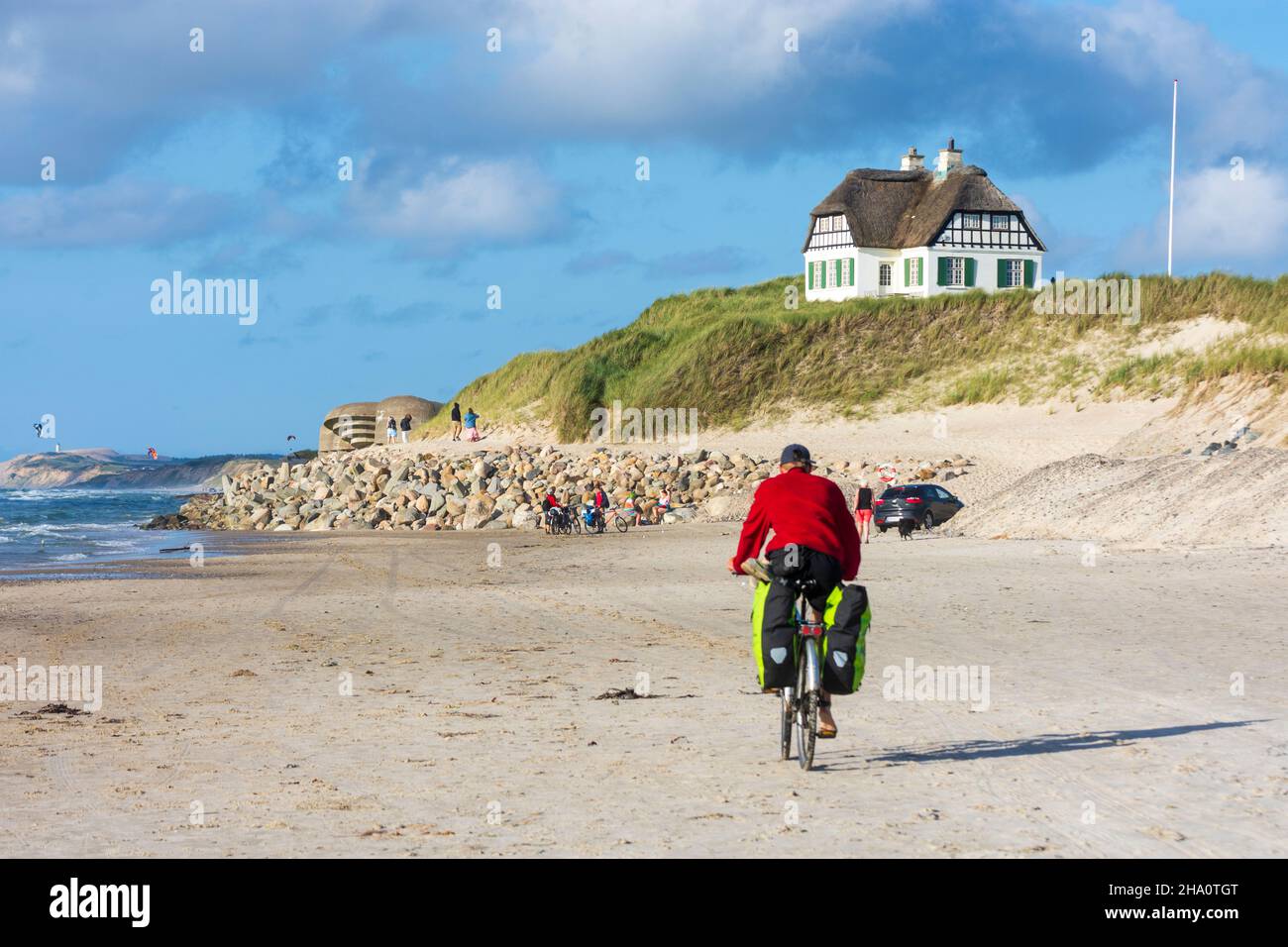 Hjoerring: beach, sea, half-timbered thatched roof house, cyclists ...