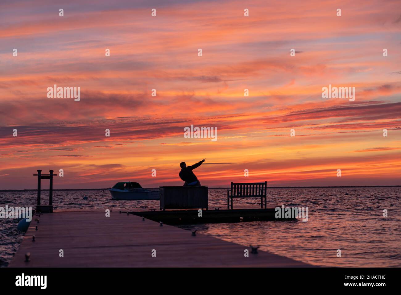 Man sitting on dock hi-res stock photography and images - Alamy