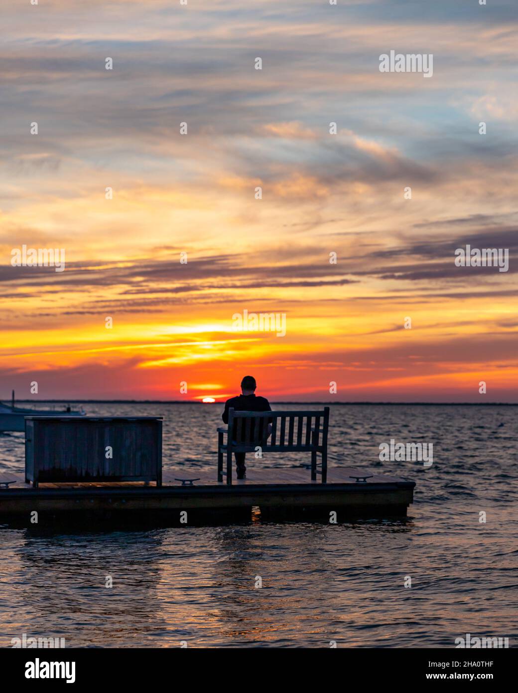 Man sitting on dock hi-res stock photography and images - Alamy