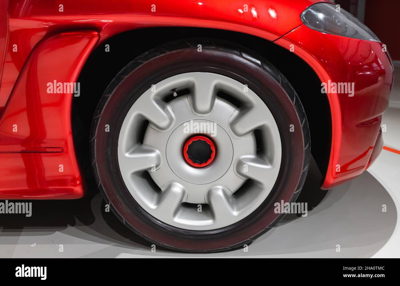 Wheel on light alloy rim of a conceptual red sports car, close up photo ...