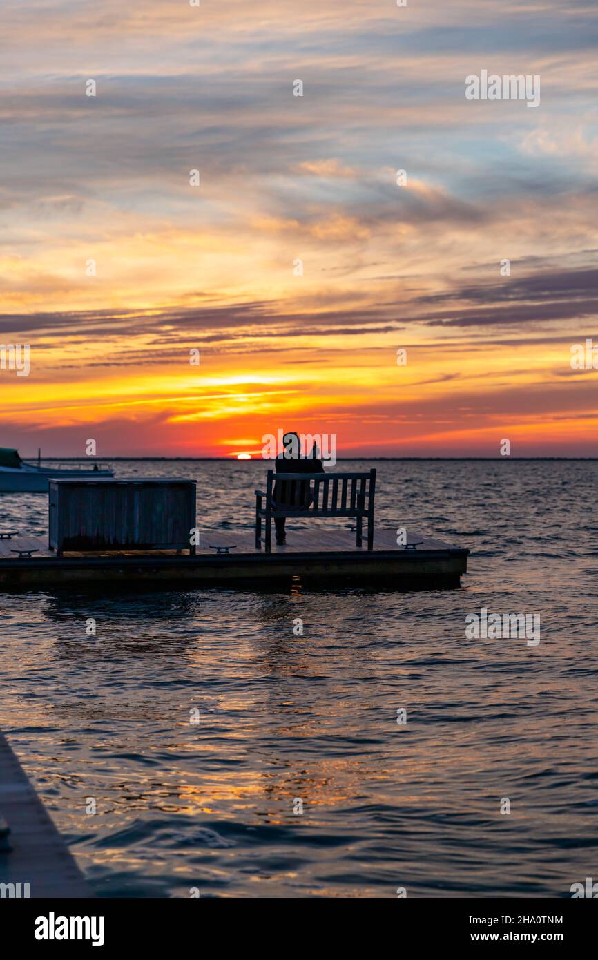 Man sitting on dock hi-res stock photography and images - Alamy