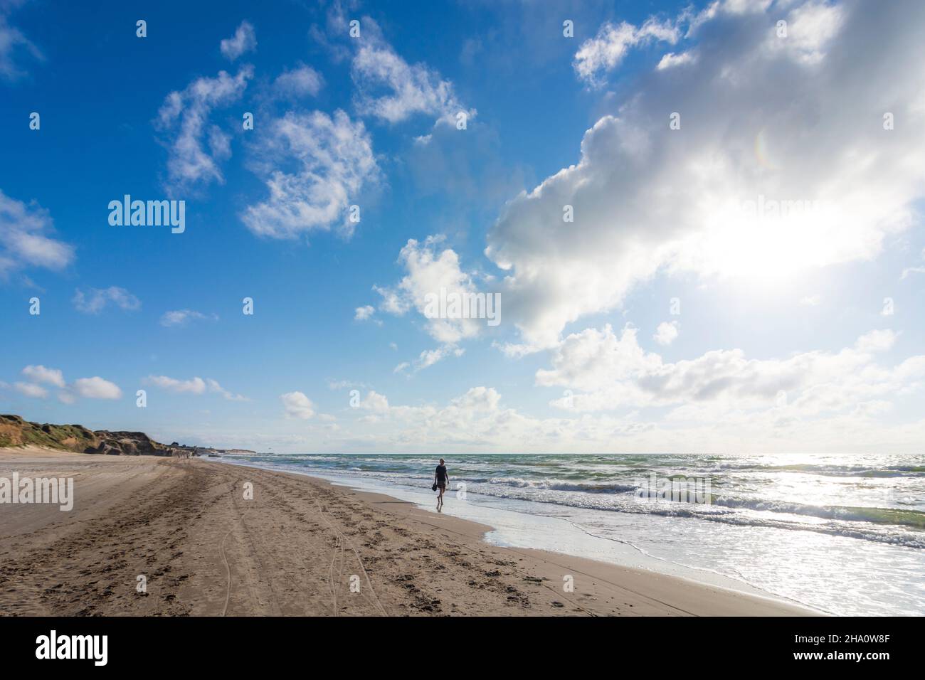 Hjoerring: man walking on beach, sea, in Loekken, Jylland, Jutland ...