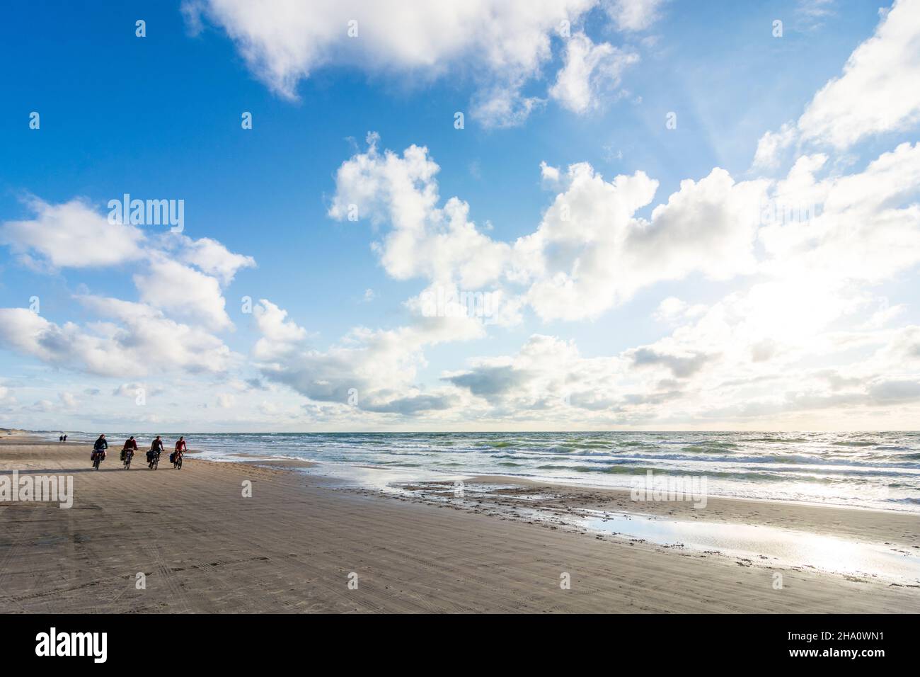 Hjoerring: cyclists on beach, sea, in Loekken, Jylland, Jutland ...