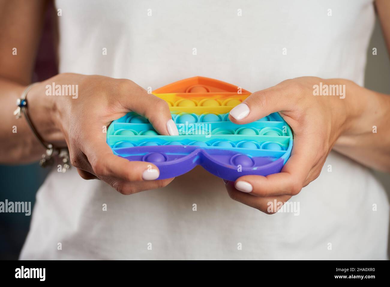 A close-up photo of a fidget toy "Pop it" in the shape of a heart in ...