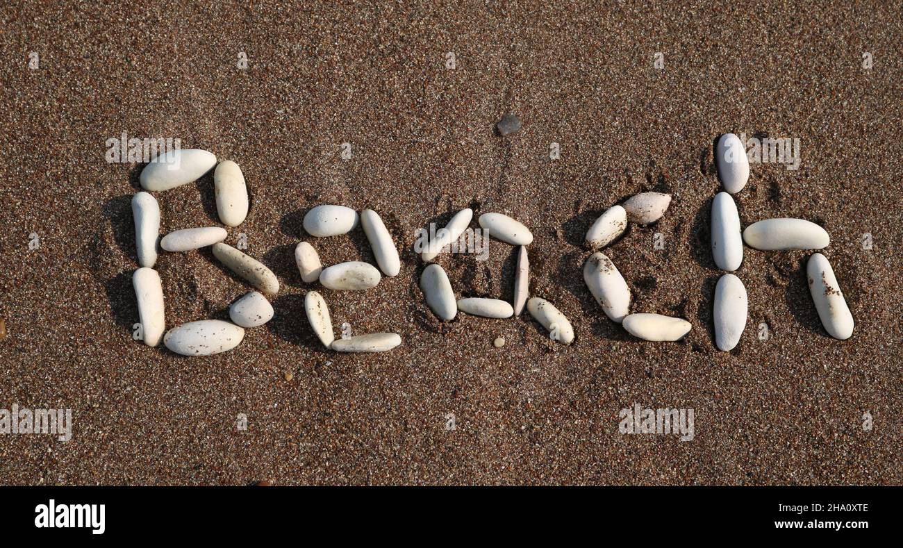 The word "Beach" written in stones on the sand on a beach in Cyprus ...